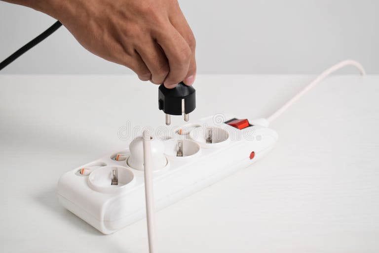 Hand Holding Electric Plug, Multiple Socket with Connected Plugs. Stock ...