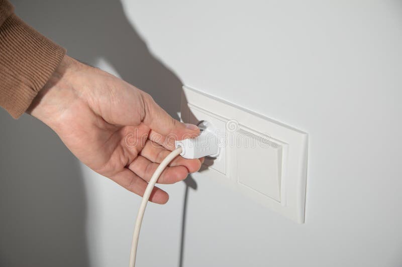 Hand Holding Electric Plug into a Power Outlet Stock Illustration ...