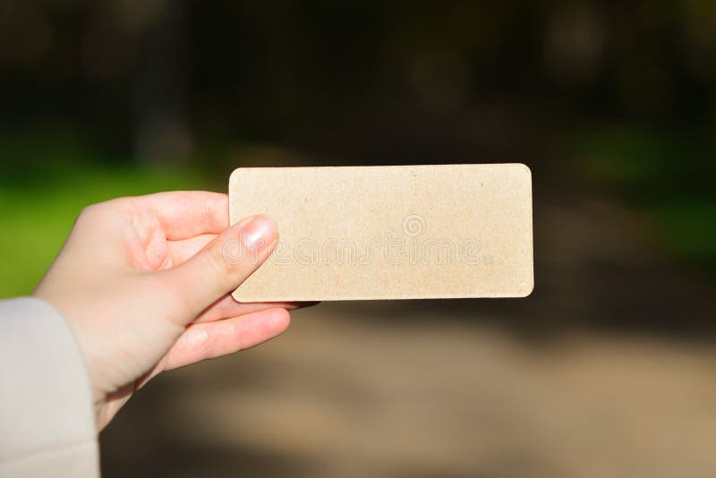 Hand Holding Empty Card in Park in Sunny Rays. Background Stock Photo ...