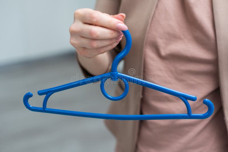 Hand Holding an Empty Cloth Hanger Stock Image - Image of hang, finger ...
