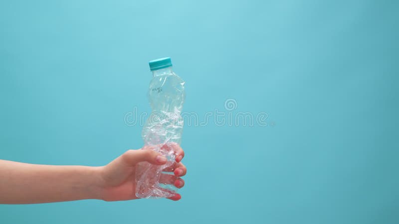 Hand Holding Empty Plastic Bottles on Blue Background Stock Video ...