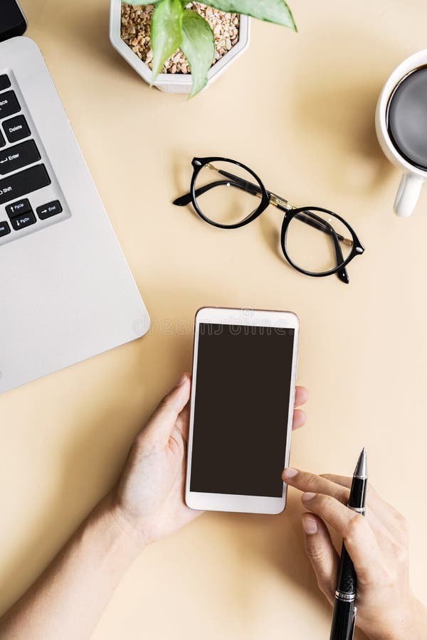 Hand Holding Empty Screen Smart Phone on Business Desk Office with Copy ...