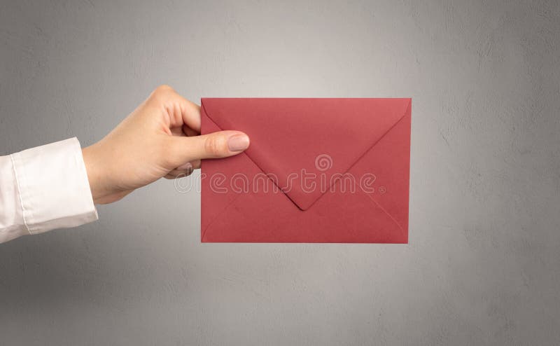 Hand Holding Envelope with Empty Wall Background Stock Photo - Image of ...