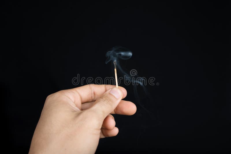 Hand Holding an Extinguished Matchstick on Black Background Stock Image ...