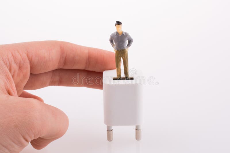 Hand Holding a Figure on an Adapter Stock Image - Image of people ...
