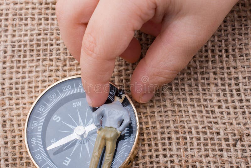 Figurine by the Side of a Compass Stock Image - Image of design ...