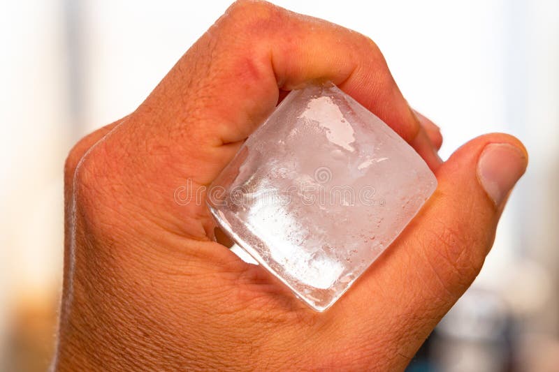 Hand Holding between the Fingers an Ice Cube, Solid Water Stock Photo ...