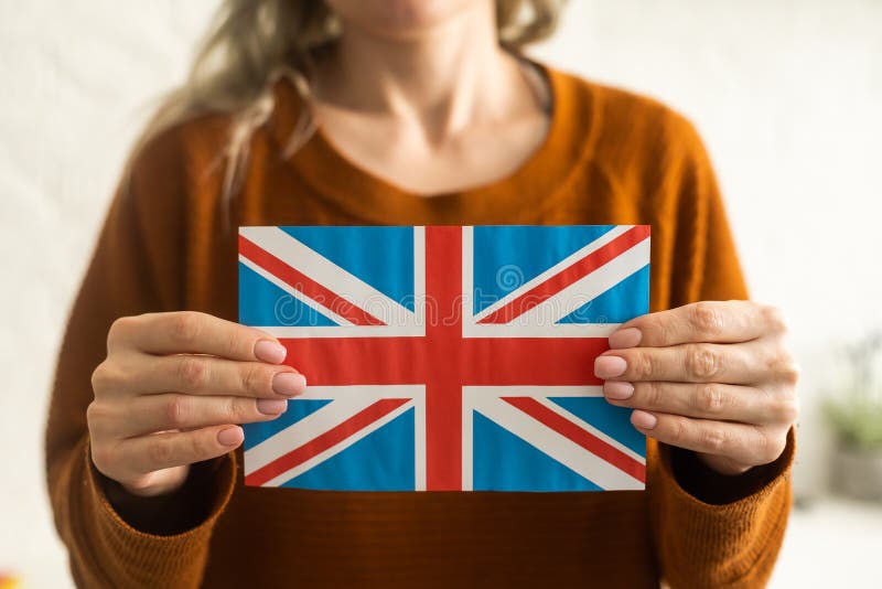 Hand Holding Flag of UK, Isolated on White Background Stock Photo ...