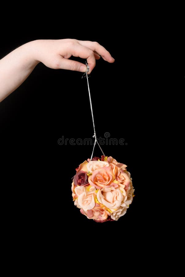 Hand Holding Flowers Arranged in the Shape of a Hanging Ball Stock ...
