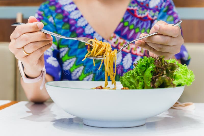 Hand Holding Fork and Spoon Eating Spaghetti. Stock Image - Image of ...