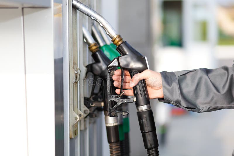 Hand holding a fuel nozzle stock photo. Image of petrol - 43814752