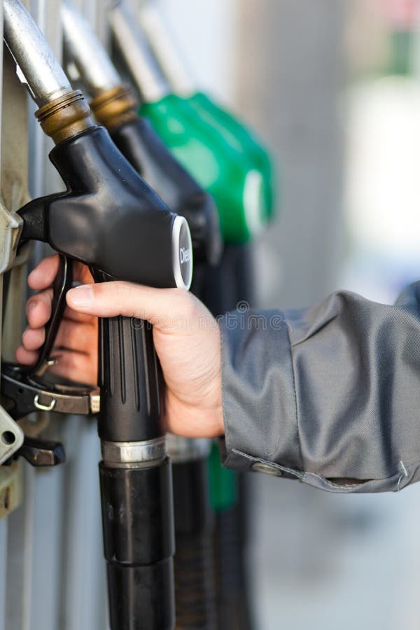 Hand holding a fuel nozzle stock photo. Image of diesel - 43814802