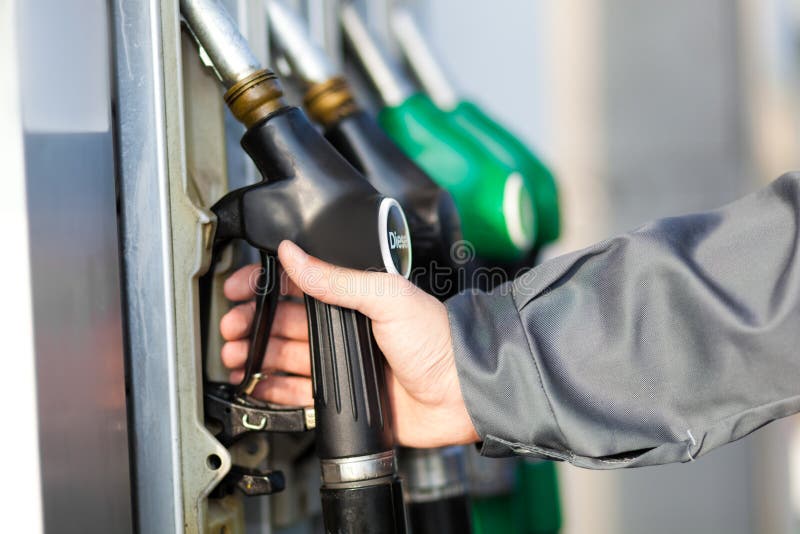 Hand holding a fuel nozzle stock image. Image of cost - 43814839