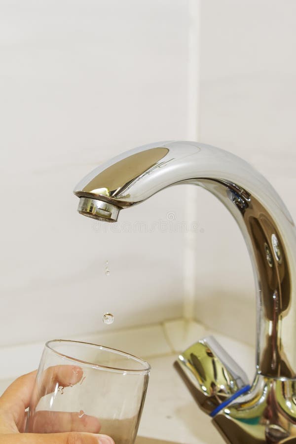 Hand Holding a Glass of Water Poured from the Kitchen Faucet Stock ... Hand Holding a Glass of Water Poured from the Kitchen Faucet Stock ...