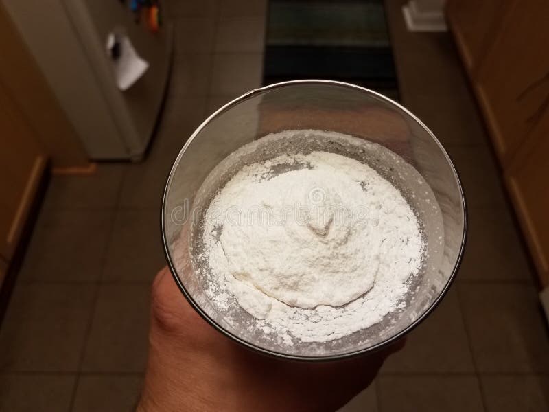 Hand Holding Glass of Water and White Powder in Kitchen Stock Photo ...