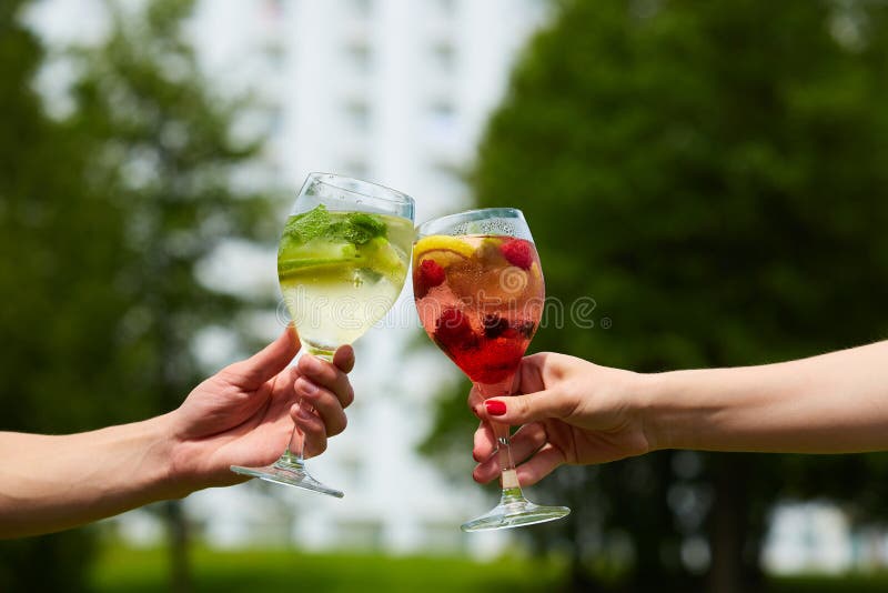 Hand Holding Glasses Cocktail Clinking Together at Outdoor. Stock Photo ...