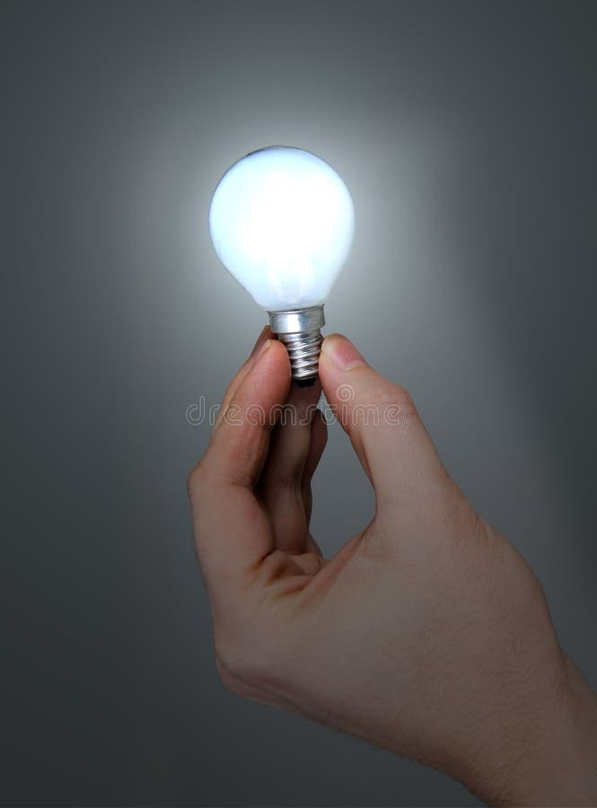 Hand Holding Glowing Light Bulb Stock Image - Image of hand, detail ...