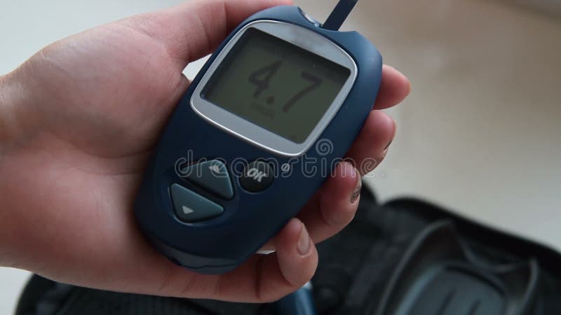 Hand Holding Glucometer Displaying Normal Blood Sugar Range Stock Video ...