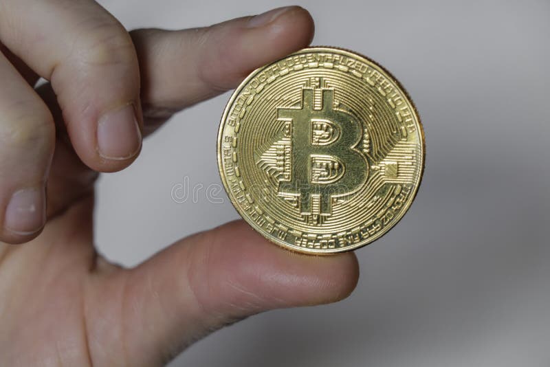 Hand Holding Gold Bitcoin Token Stock Photo - Image of electronic, bank ...