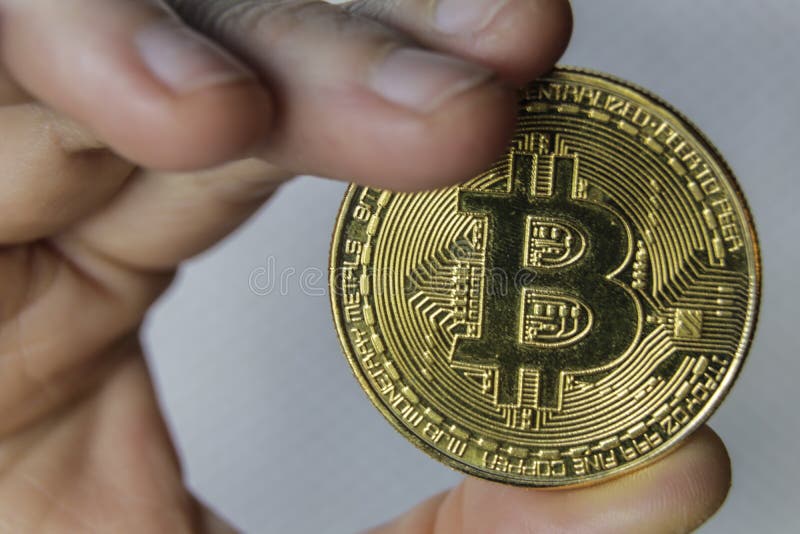 Hand Holding Gold Bitcoin Token Stock Photo - Image of hand, cash ...