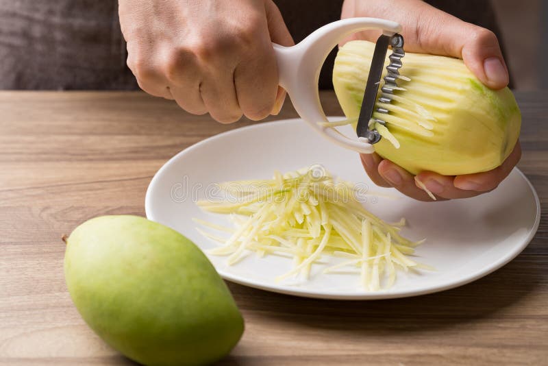 Hand Holding Grater and Shredding Green Mango To Making Salad Stock ...