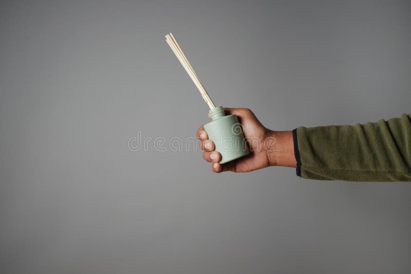 Hand Holding a Green Diffuser with Reeds for Aromatic Fragrance Stock ...