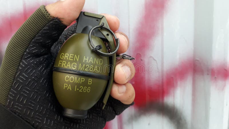 Hand holding grenade stock photo. Image of watch, gadget - 182160134