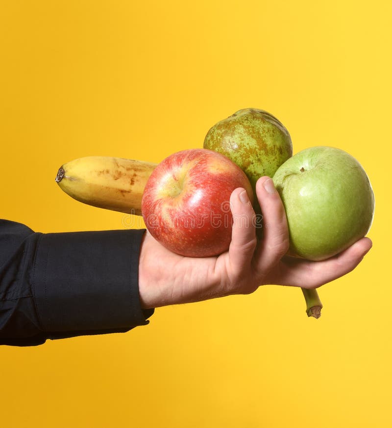 Hand Holding a Group of a Fruits on Yellow Background Stock Image ...
