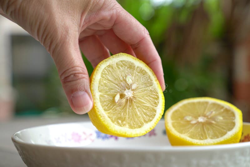 Hand Holding Half of a Cut Lemon Stock Image - Image of fingers ...