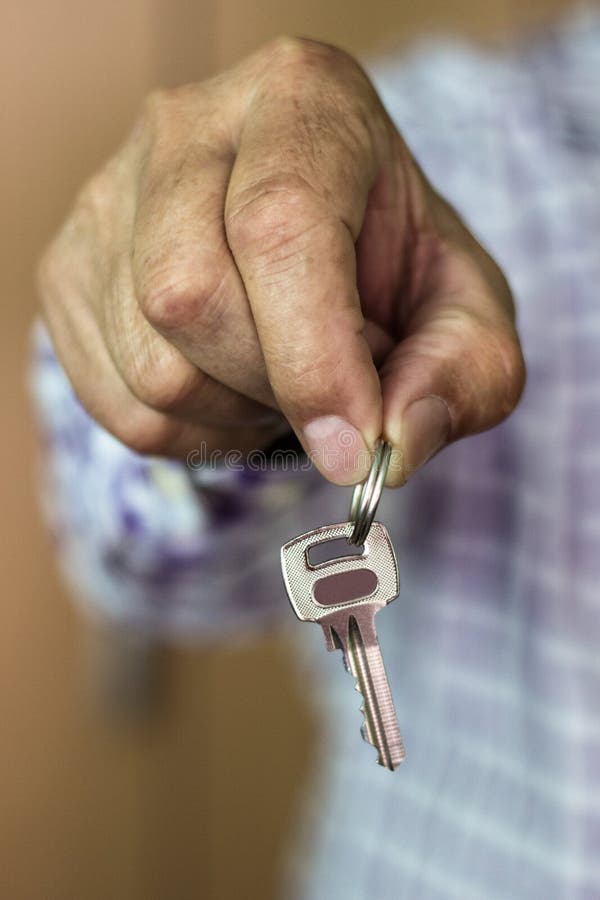 Hand holding House Key stock photo. Image of interior - 93498606