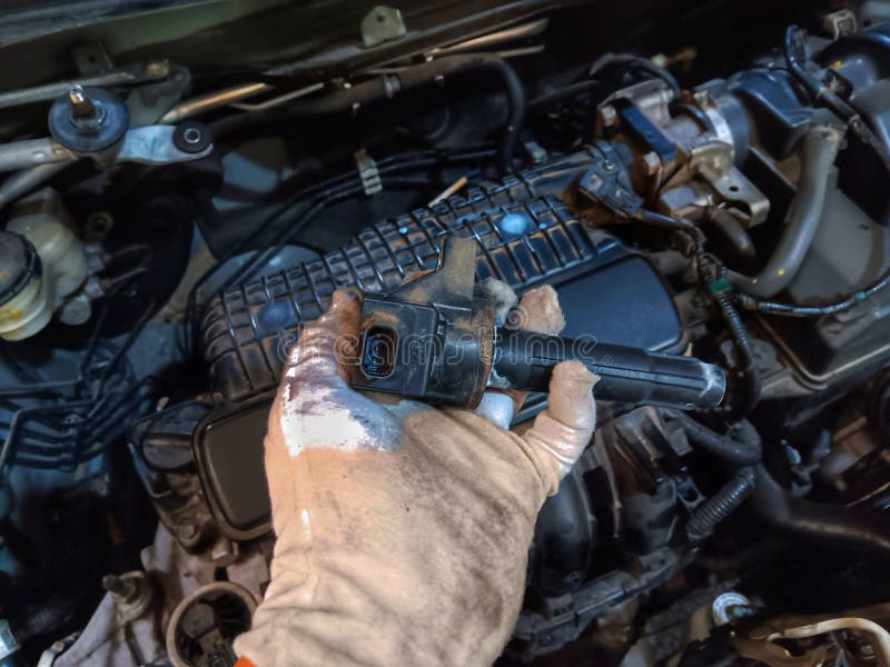 Hand Holding Ignition Coil on Spark Plug Stock Photo - Image of desk ...