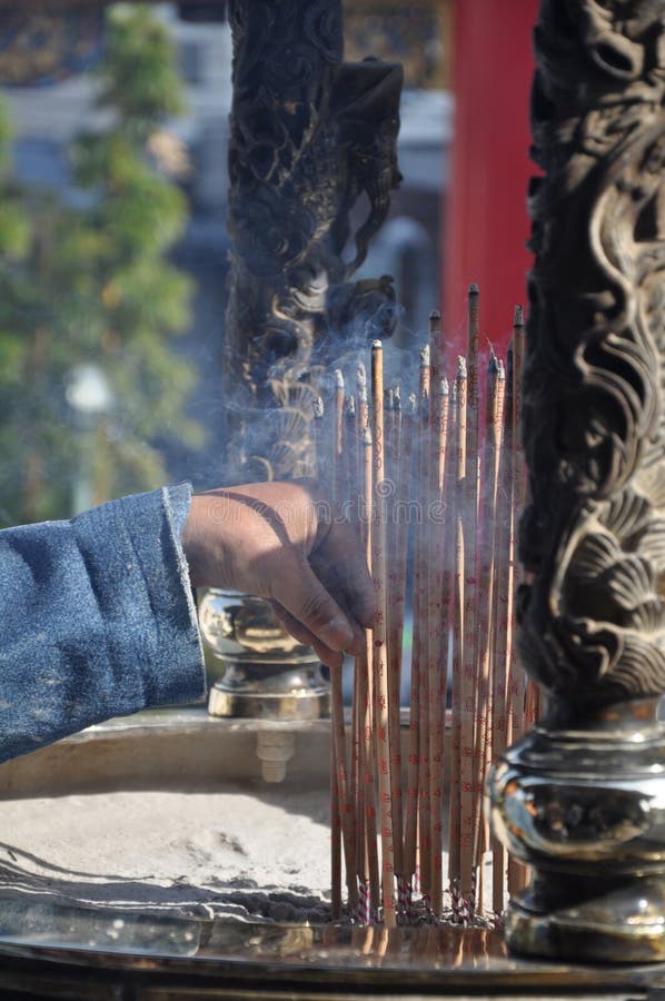 Hand Holding Incense Sticks in a Chinese Temple Stock Photo - Image of ...