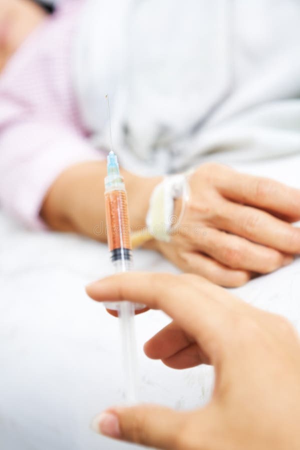Hand Holding Injection with Patient Stock Photo - Image of syringe ...