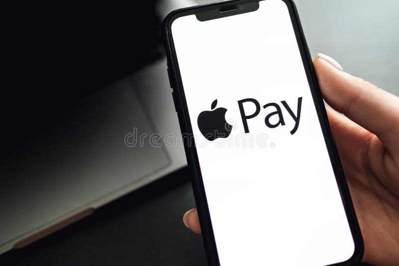 Hand Holding the IPhone X with Apple Pay Logo on the Screen. Editorial ...