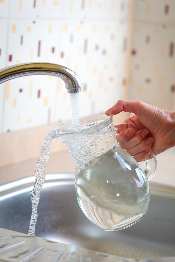 Hand holding jug stock image. Image of background, flowing - 44422987