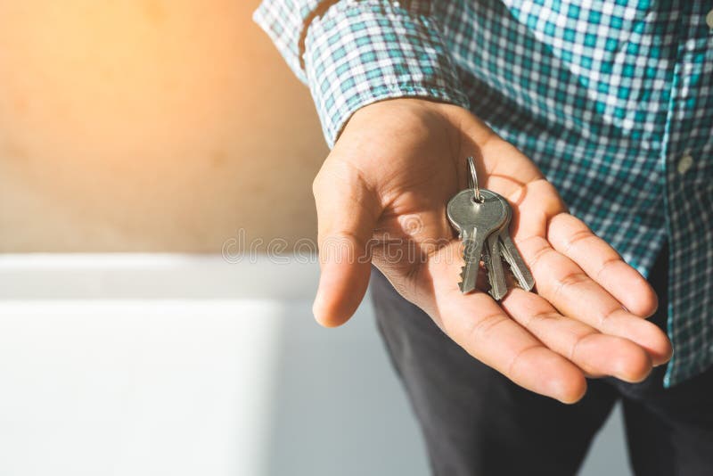 Close Up Hand Holding Key in House. Stock Image - Image of estate ...