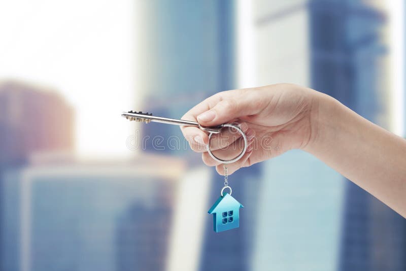 Hand Holding Key with a Keychain Stock Photo - Image of blue, concept ...