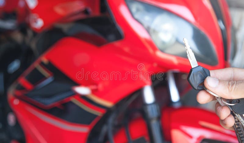 Hand Holding a Keys in the Garage, on the Background of Motorcycle ...