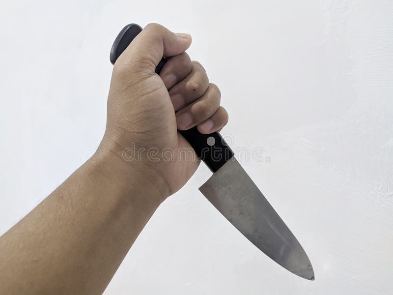 A hand holding a knife stock photo. Image of holding - 229291198
