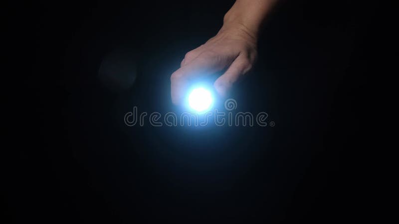A Hand Holding a Led Flashlight with Blue Beam and Shine in Camera in ...