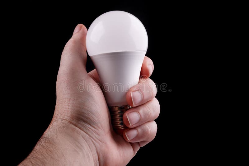 Hand Holding LED Light Bulb on Black Background Stock Photo - Image of ...