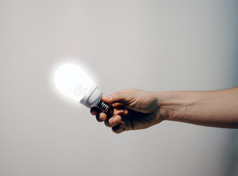 Hand holding light bulb stock image. Image of electricity - 3984625