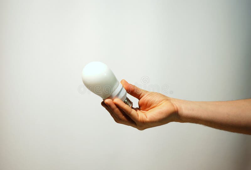 Hand holding light bulb stock photo. Image of holding - 4052740