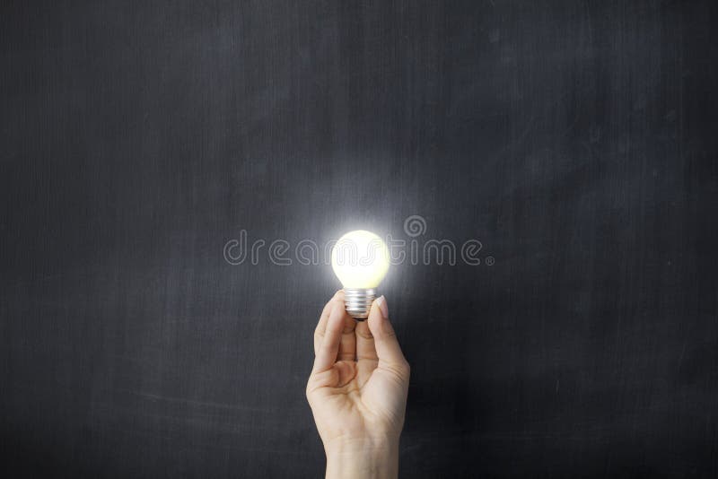 Hand holding light bulb stock photo. Image of holding - 62877410