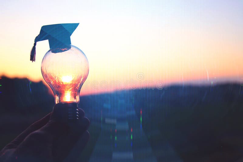 A Hand Holding a Light Bulb and Graduation Cap in Front of the Sun ...