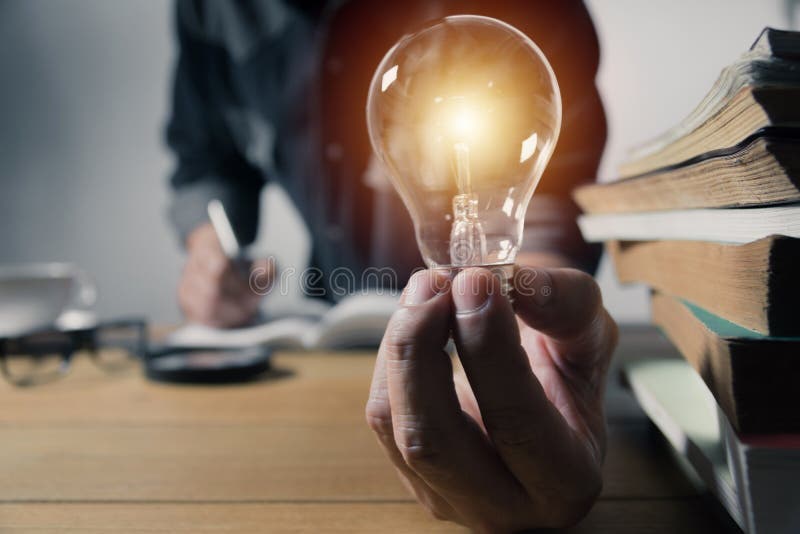 Hand Holding a Light Bulb. Innovation and Creative Concept Stock Photo ...