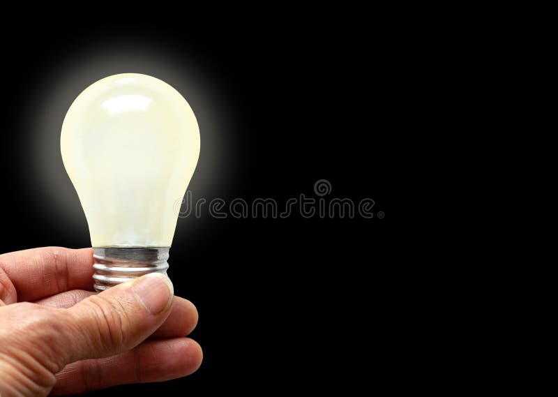 Hand Holding Lighted Bulb with Black Background and Copy Space Stock ...