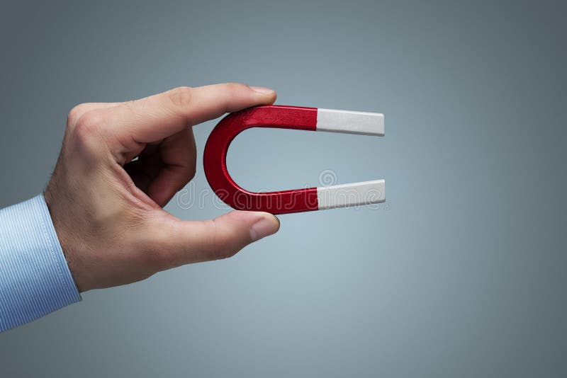 Hand holding magnet stock photo. Image of field, attract - 69716762