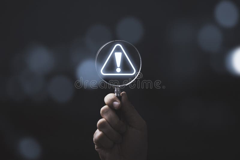 Hand Holding Magnifier Glass with Red Triangle Caution Warning Sign for ...