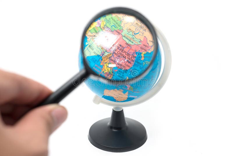 Hand Holding Magnifying Glass Over Earth Globe Stock Photo - Image of ...